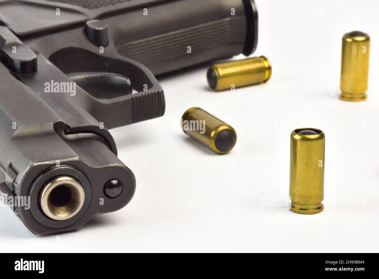 Traumatic pistol with barrel in frame close-up and several cartridges ...