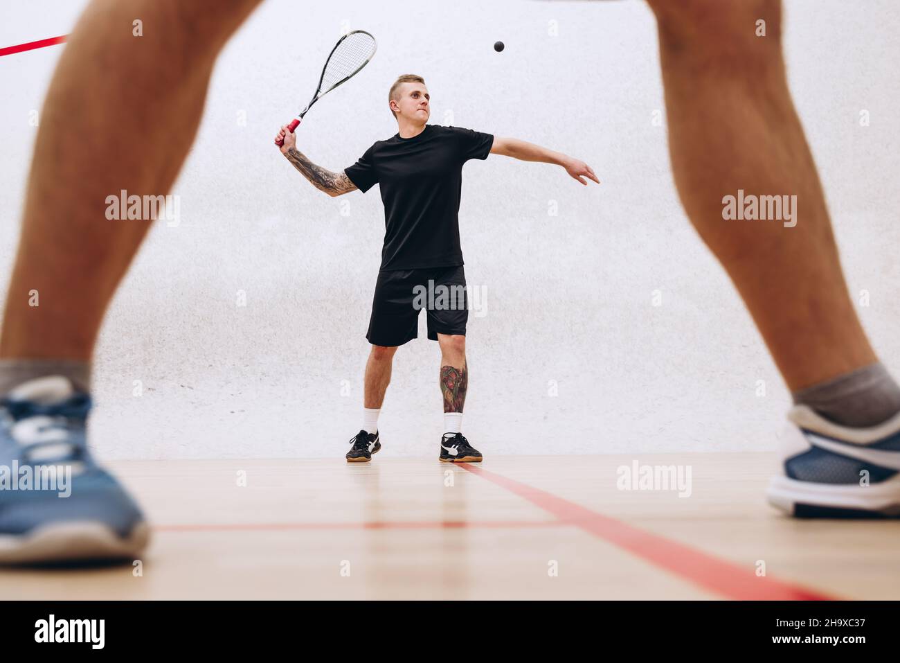 Portrait of sportsman, young boy playing squash, serving ball isolated ...