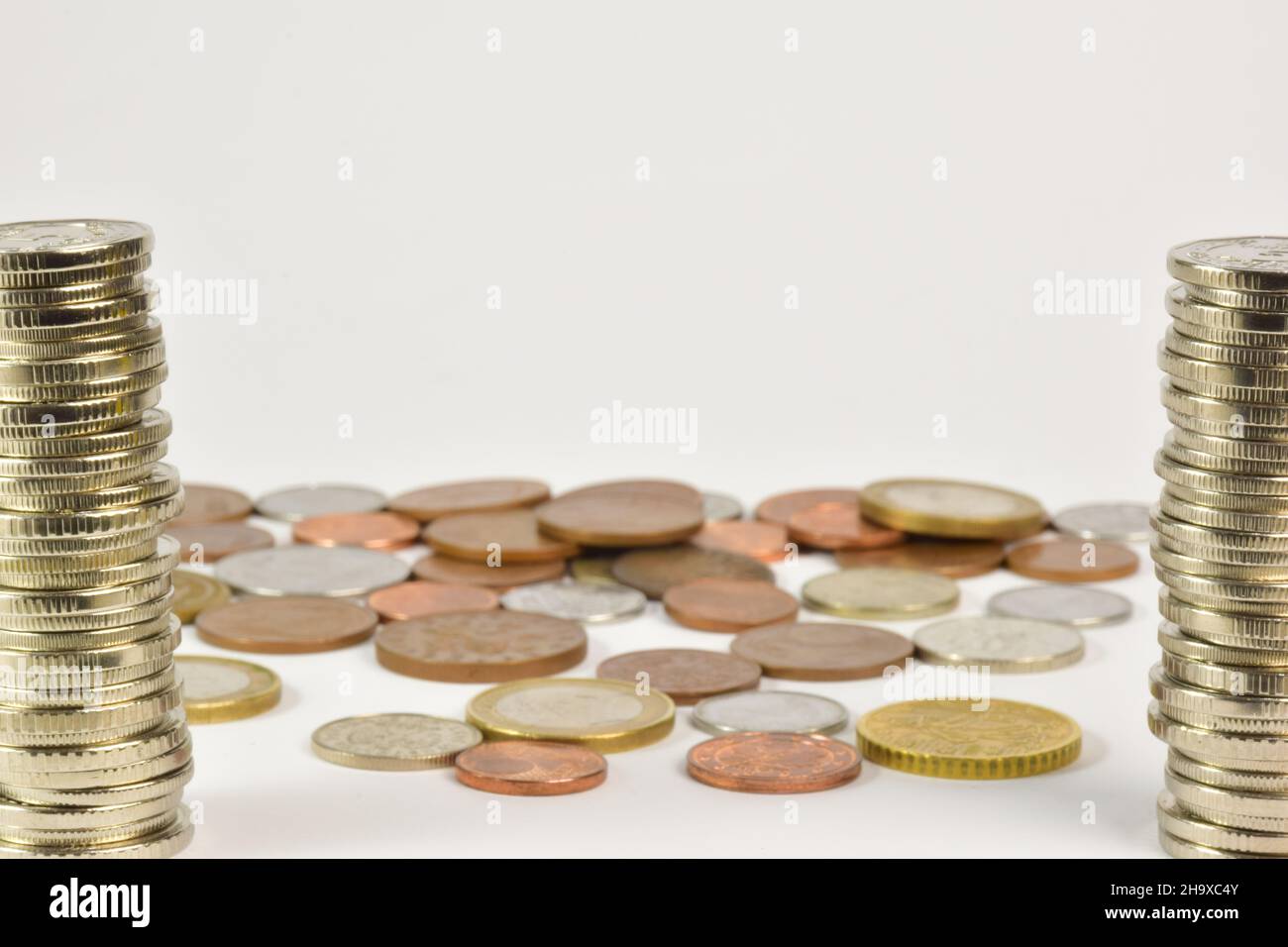 Two stacks of coins are close-ups on the sides of the frame, and a ...
