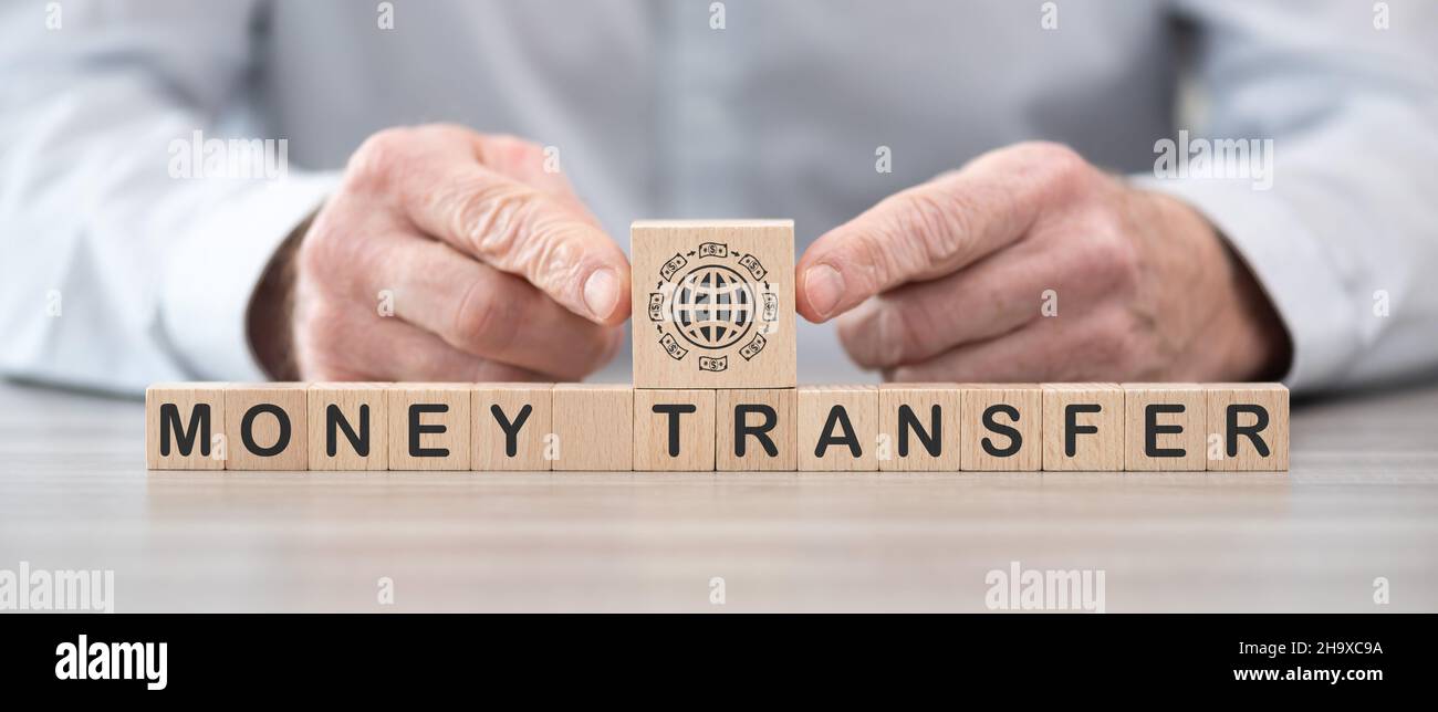 Wooden blocks with symbol of money transfer concept Stock Photo - Alamy
