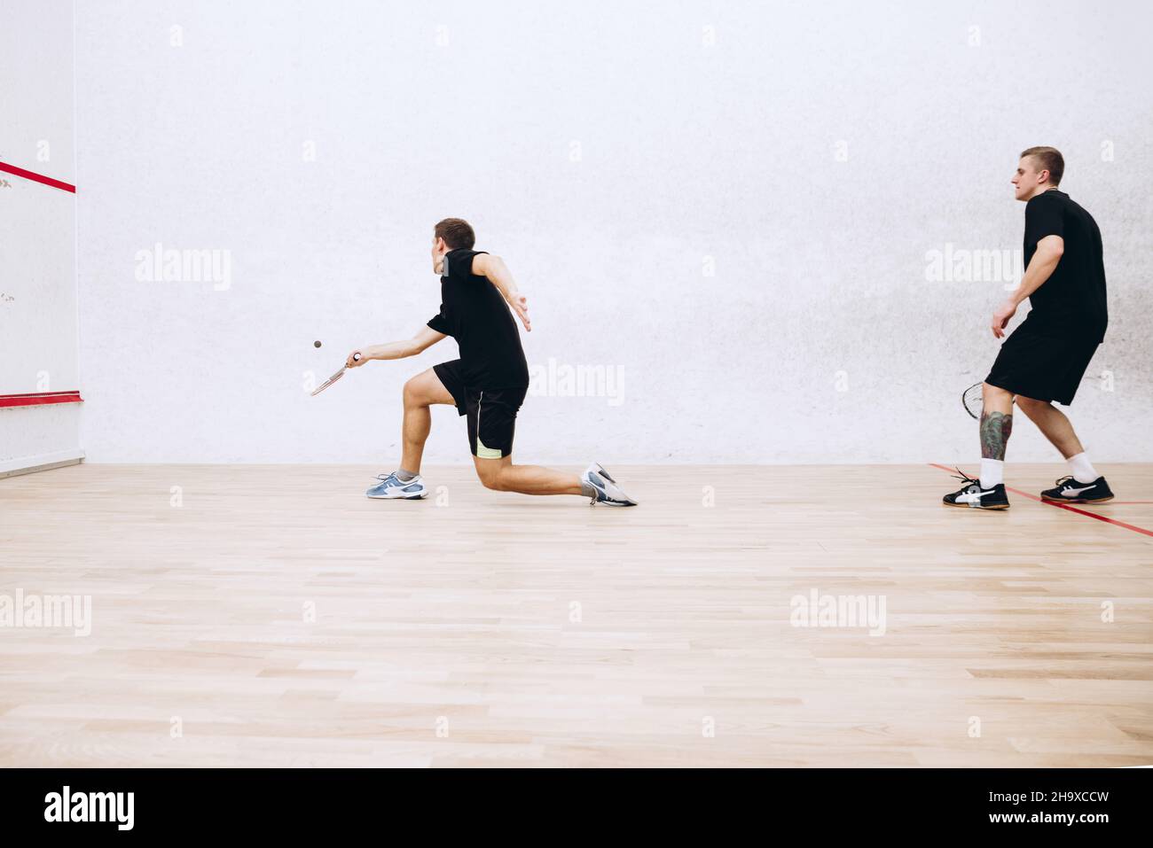 Full-length side view portrait of two young boys in motion, playing ...