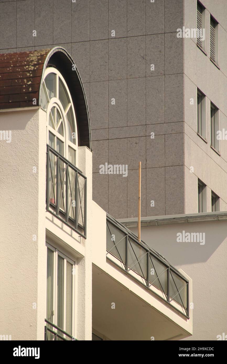 Vertical shot of an arched residential building with a balcony in ...