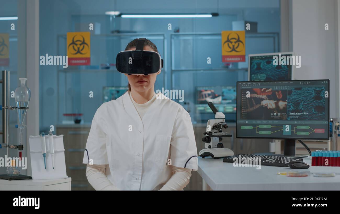 Chemist working with virtual reality headset in laboratory, using vr ...