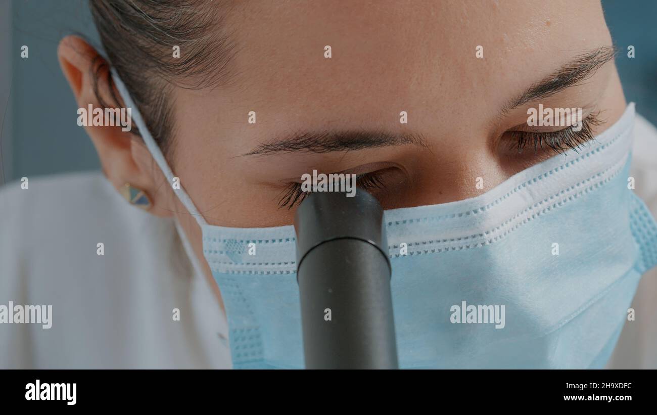 Woman scientist using microscope with magnifying glass for science ...