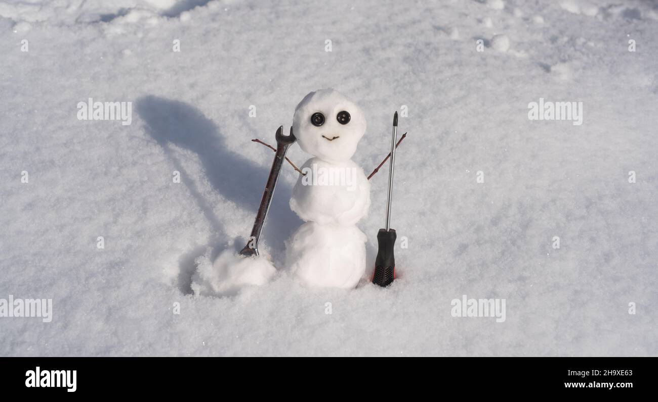 Snow man. Happy snowman on snow, funny winter time. Repairman with ...