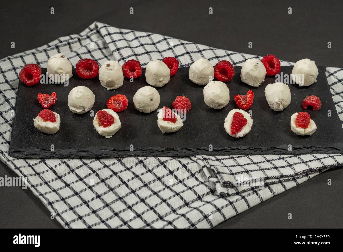 fresh goat cheese balls with raspberries Stock Photo - Alamy