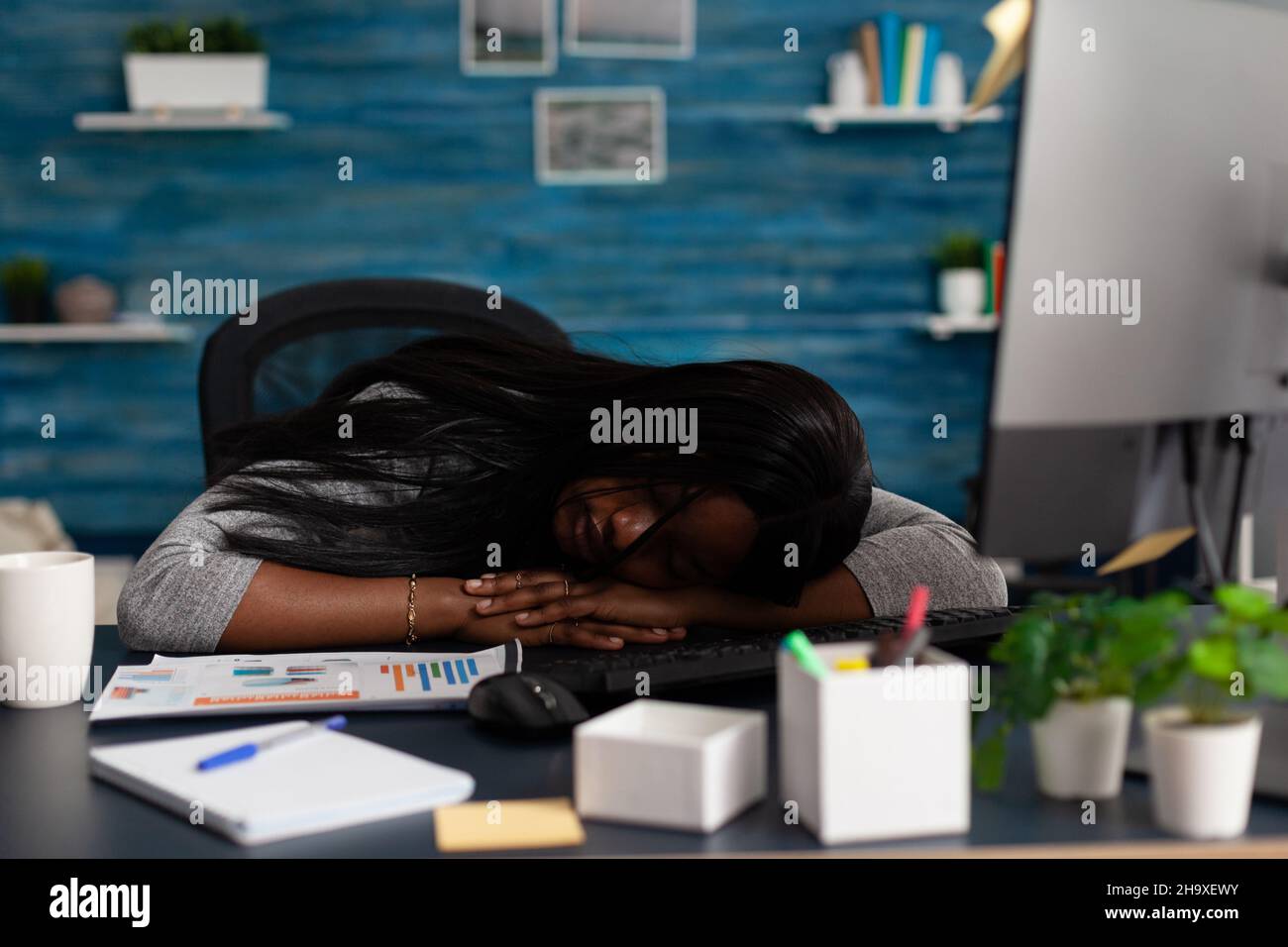 Tired worker falling asleep on desk while working from home on papers ...