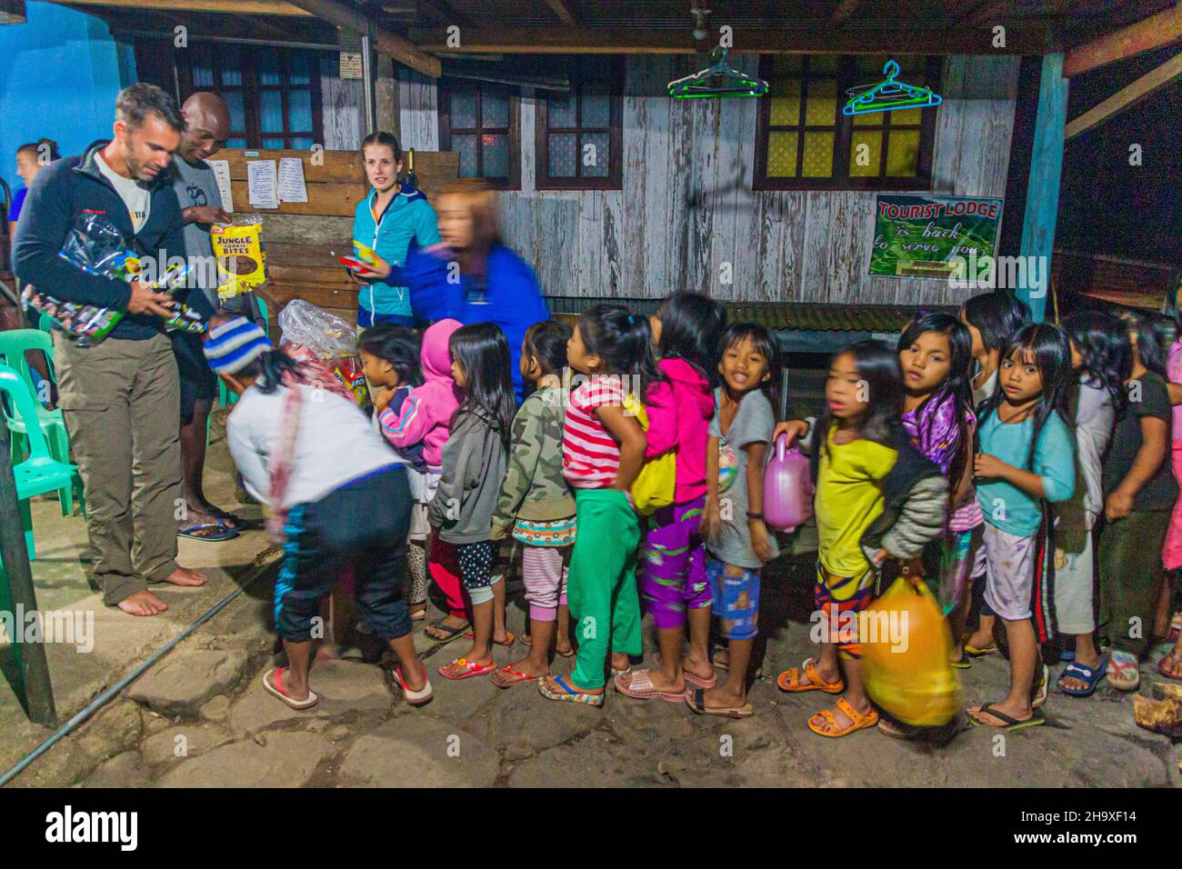CAMBULO, PHILIPPINES - JANUARY 21, 2018: Tourist is giving biscuits to ...
