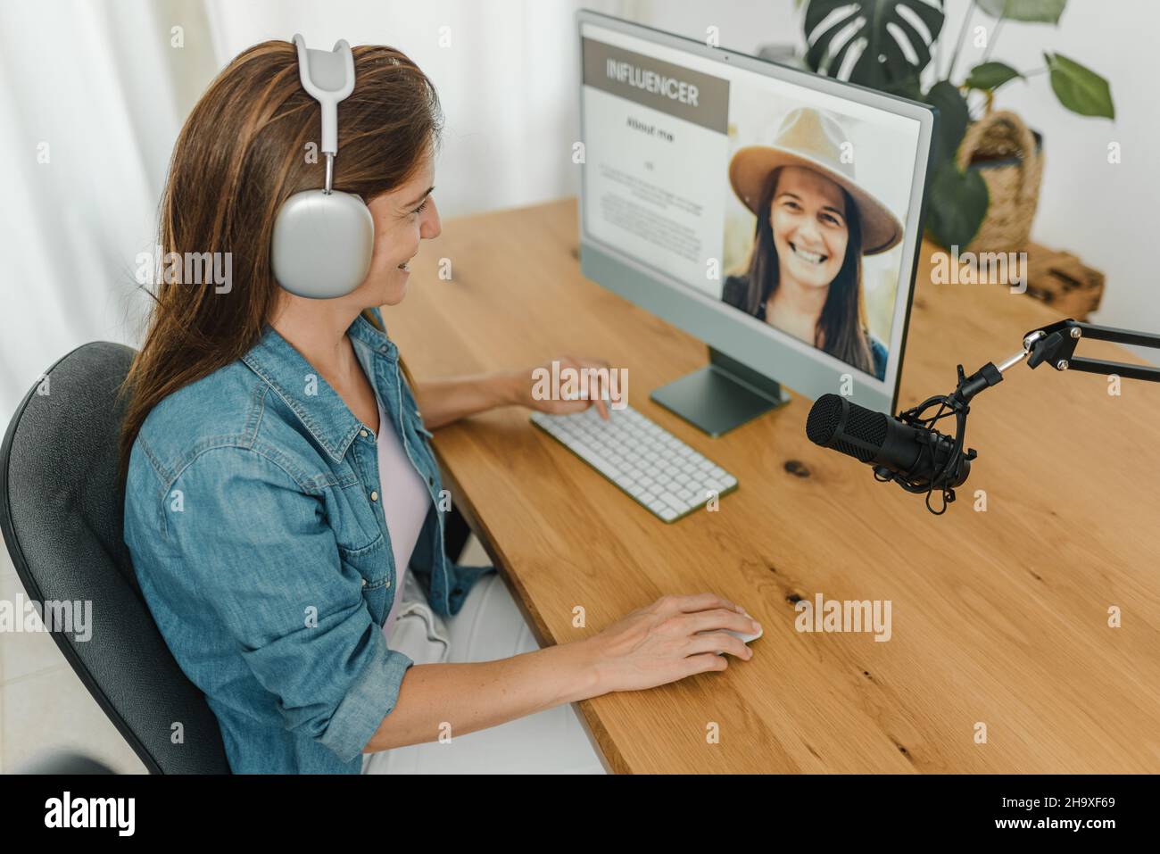 Radio host recording podcast and using computer Stock Photo - Alamy
