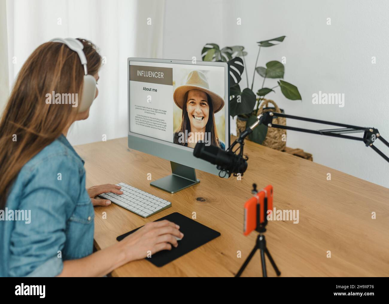 Female influencer using computer in recording studio Stock Photo - Alamy