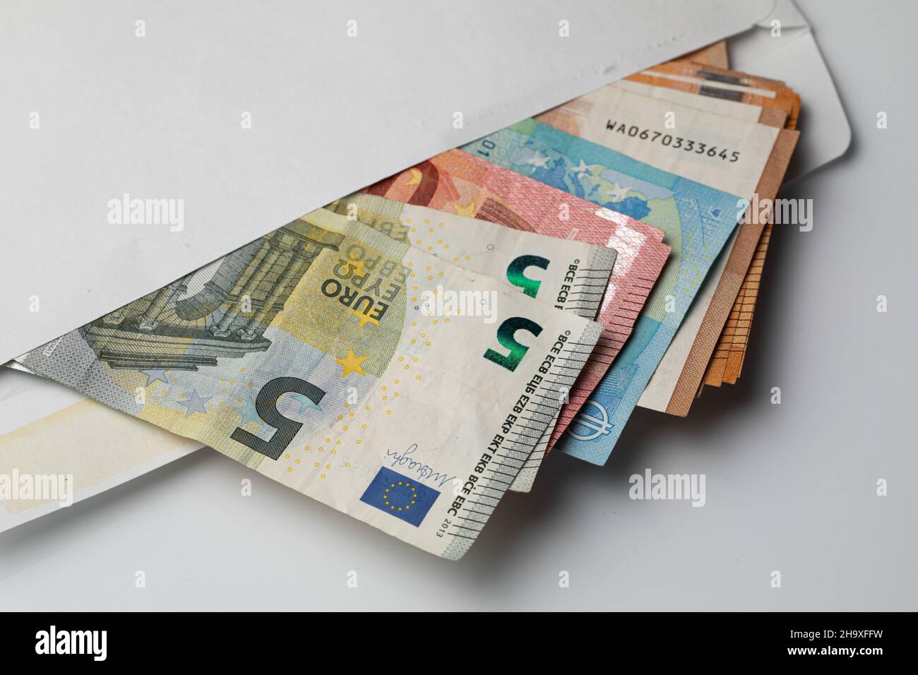 Closeup with envelope full of Euro banknotes on white background Stock ...