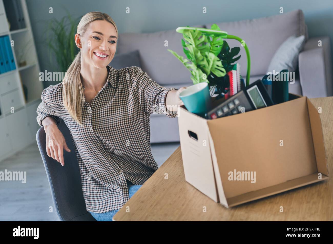 Photo of optimistic lady manager marketer pack cardboard box hope find ...