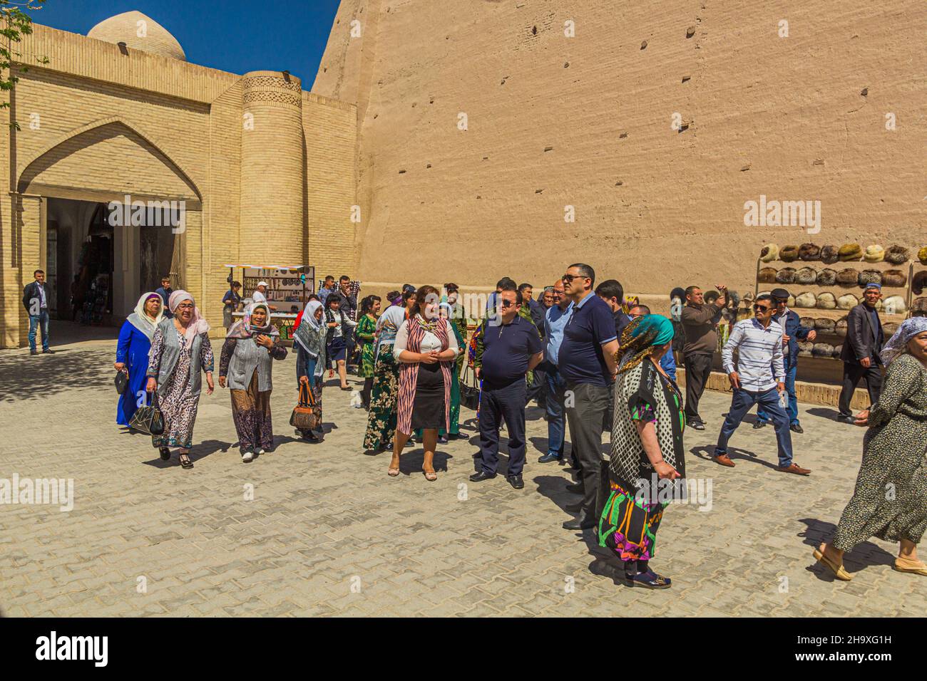 KHIVA, UZBEKISTAN - APRIL 26, 2018: Tourists visit the old town of ...