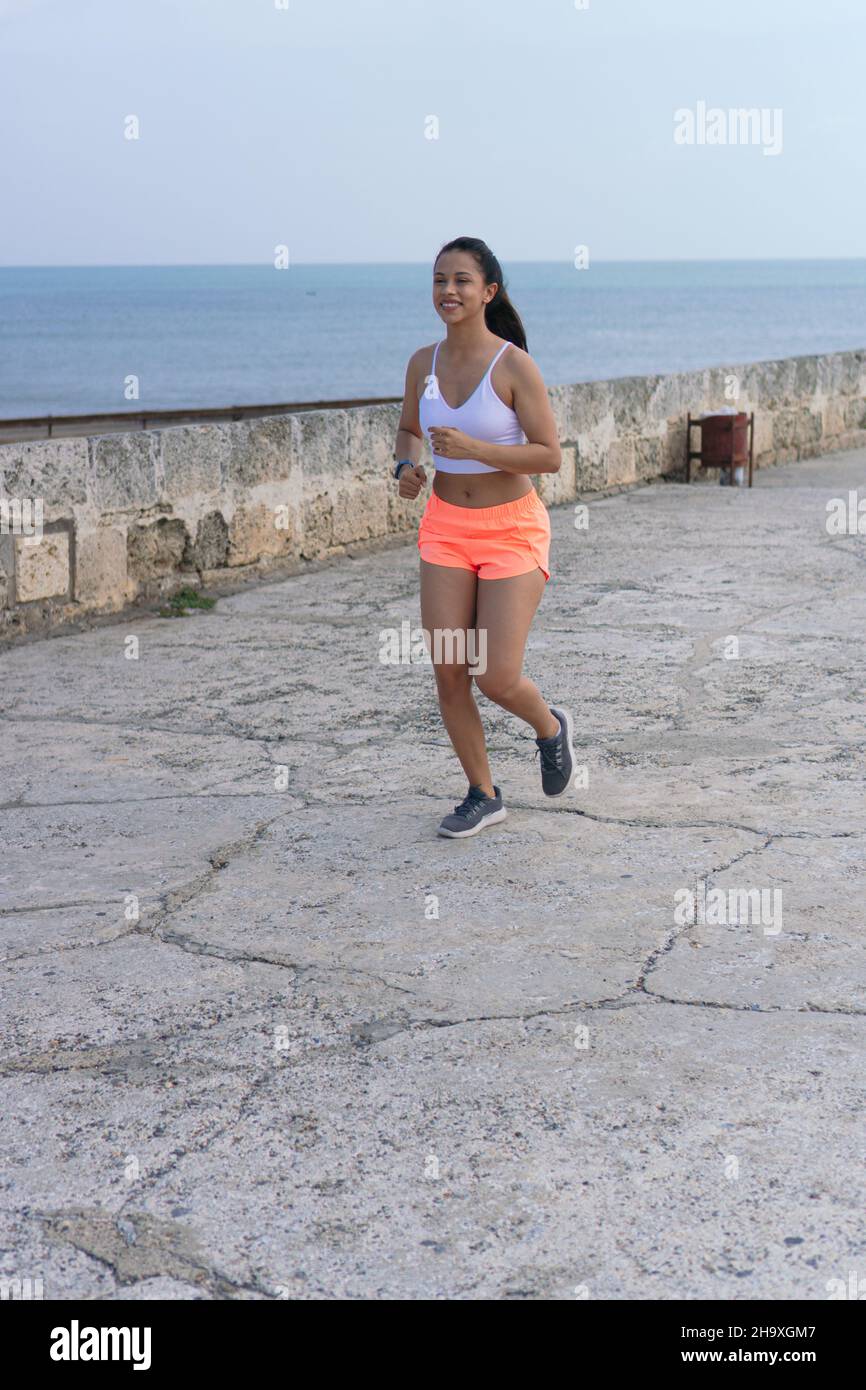 Woman running through the city hi-res stock photography and images - Alamy