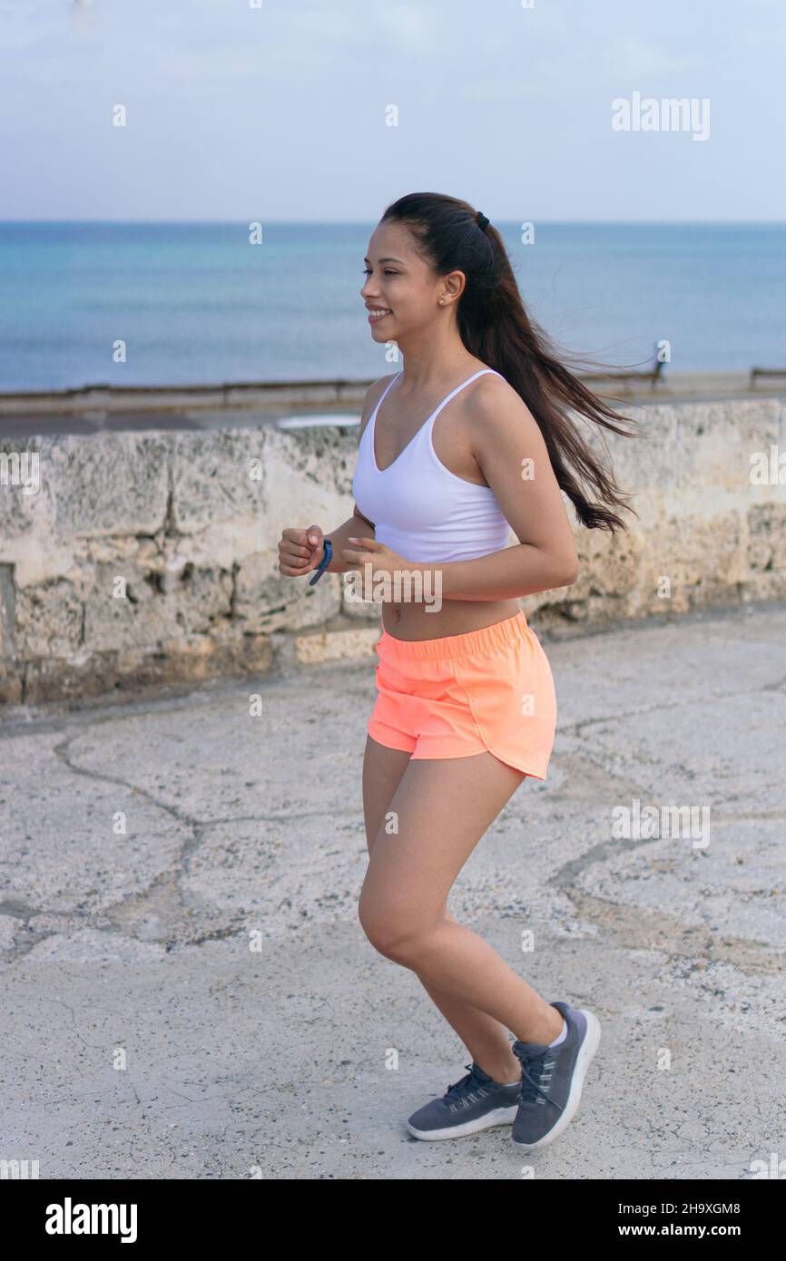 Woman running through the city hi-res stock photography and images - Alamy