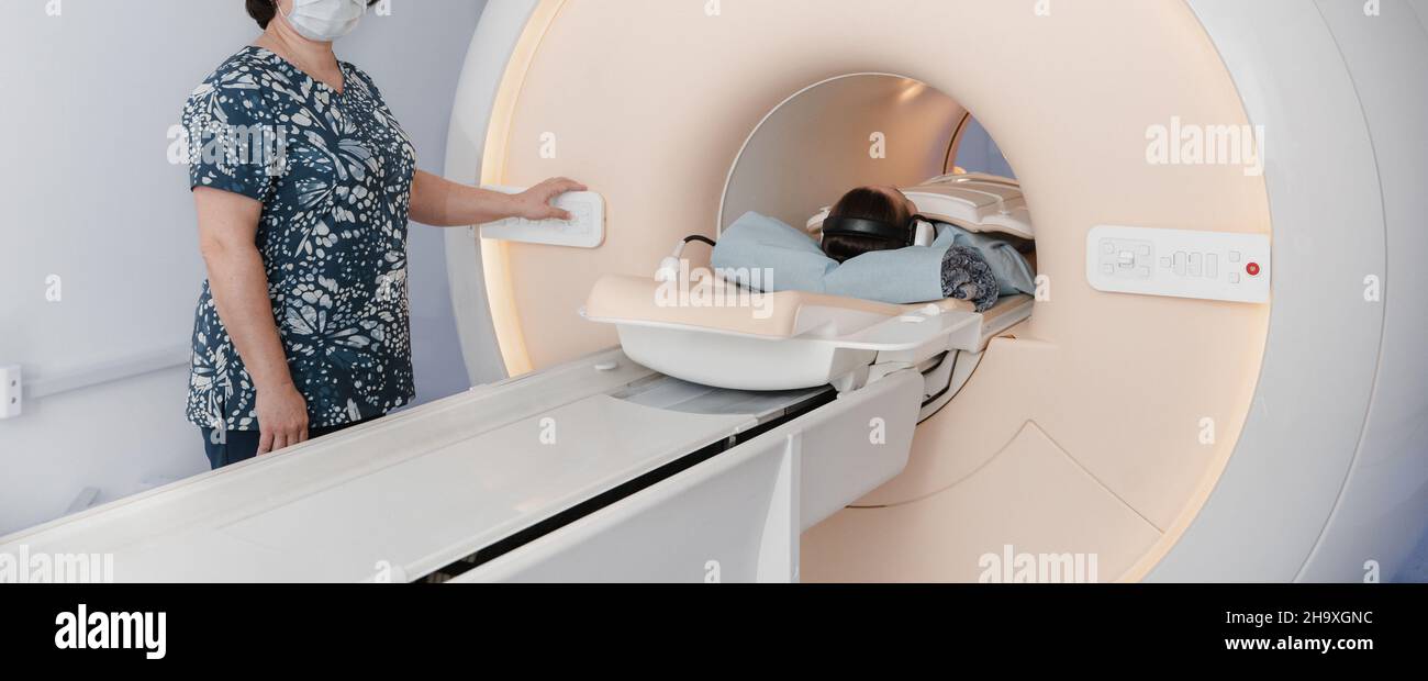 Doctor or nurse and patient with tomography CT or MRI Scan in hospital ...
