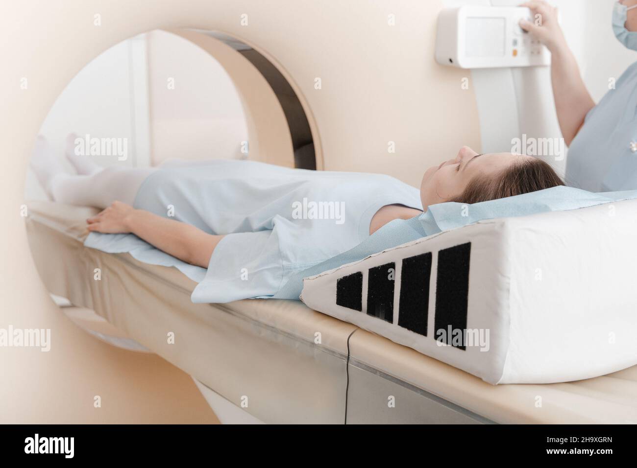 Doctor or nurse and patient with tomography CT or MRI Scan in hospital ...