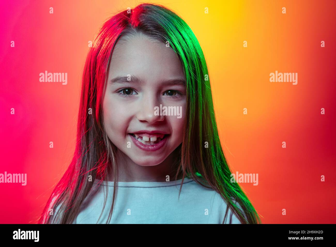 Close-up preschool girl, happy kid with long glossy hair looking at ...
