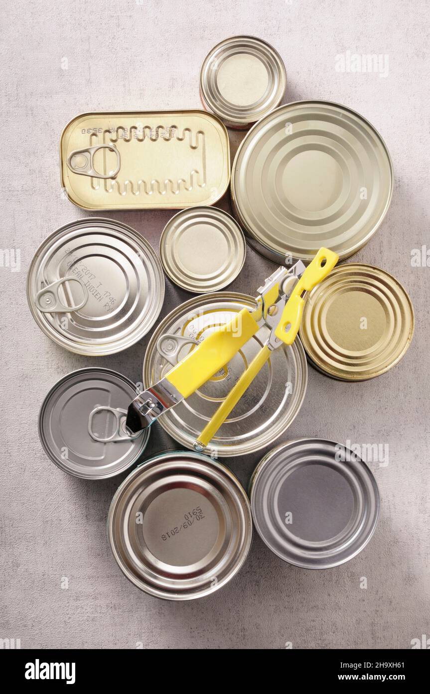 Various tins of food with a tin opener (seen from above Stock Photo - Alamy
