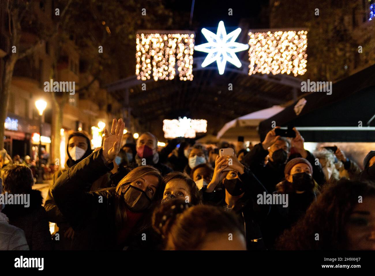 People stand in Avenida Gaudì street as a new star is lit on top of the ...