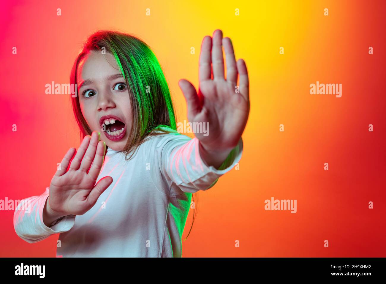 Portrait of little scared girl, kid defends against attack of ...