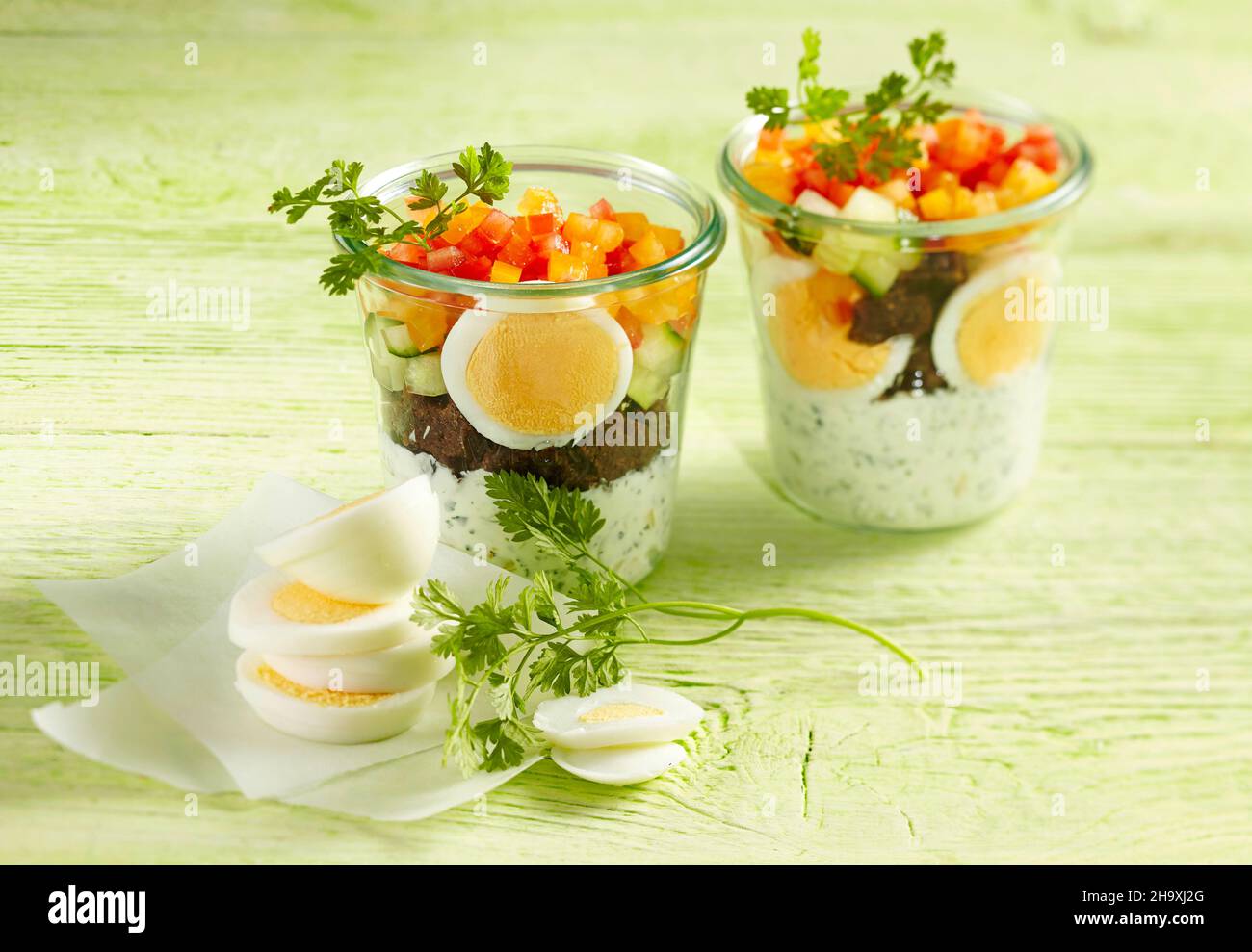 Boiled eggs with pumpernickel and herb quark in glass jars Stock Photo ...