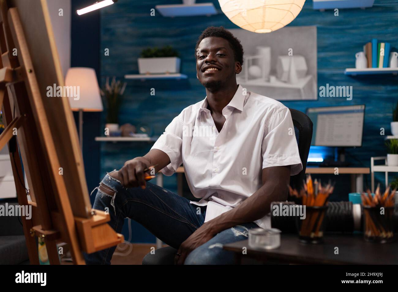 Portrait of smiling man illustrator smiling with graphic pencil in hand ...