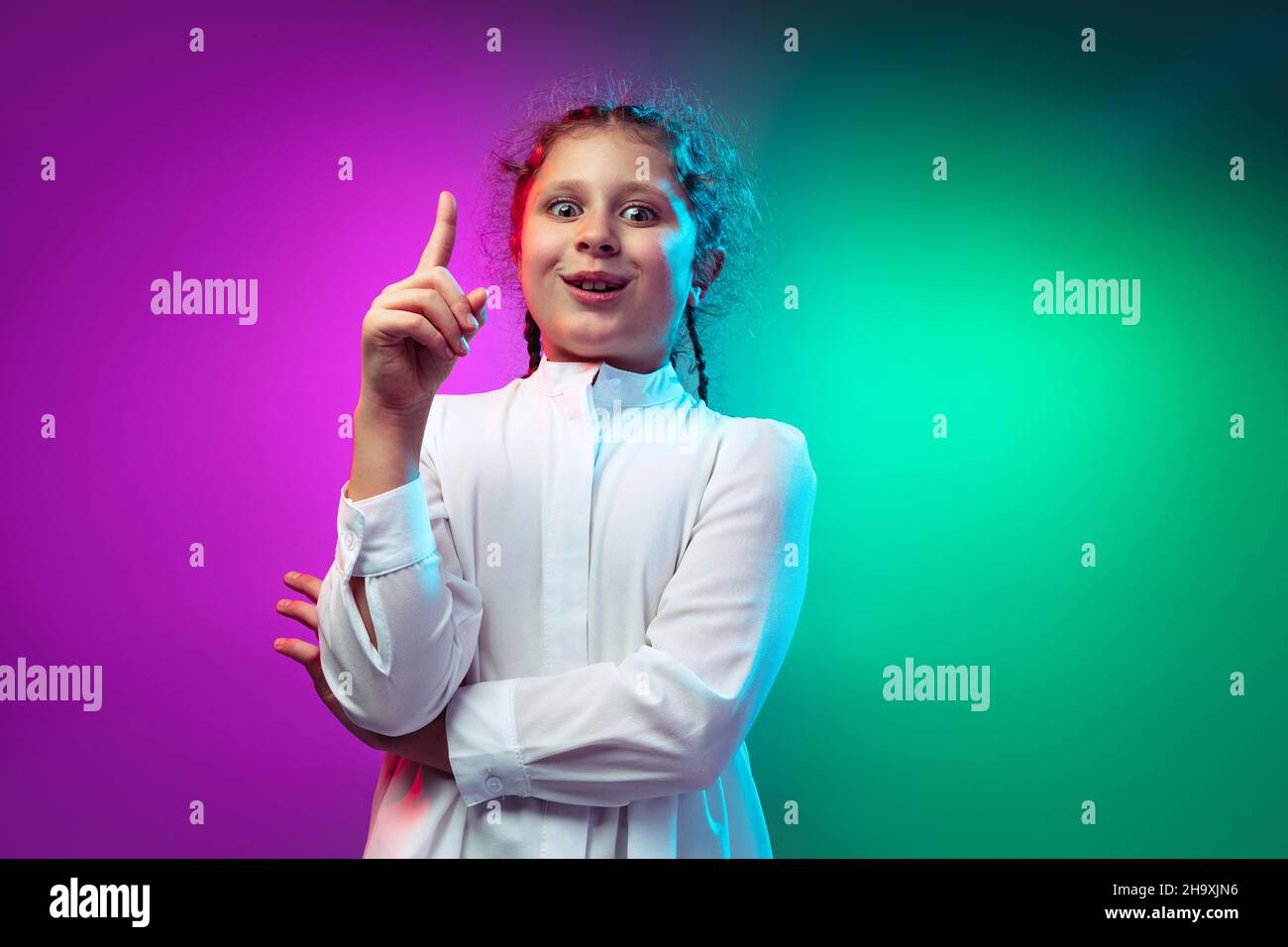 Portrait of little preschool girl, cute kid raising finger up isolated ...
