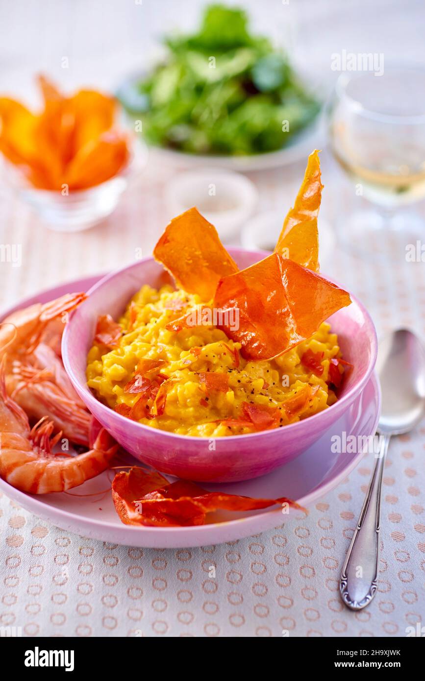 Saffron risotto with prawns and ham Stock Photo - Alamy