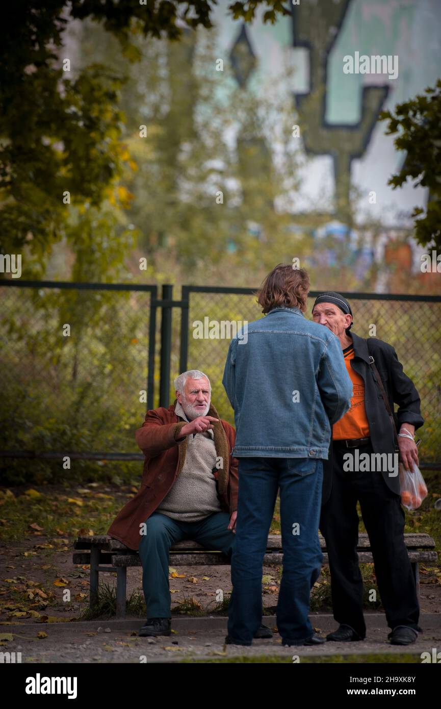 VILNIUS, LITHUANIA - OCTOBER 6 2021: Men drinking alcohol on a bench ...