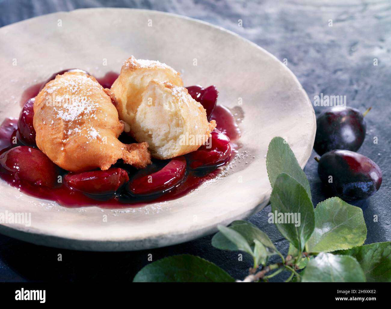 Mutzen (Karneval pastry from the Rhineland, Germany) in plum compote ...