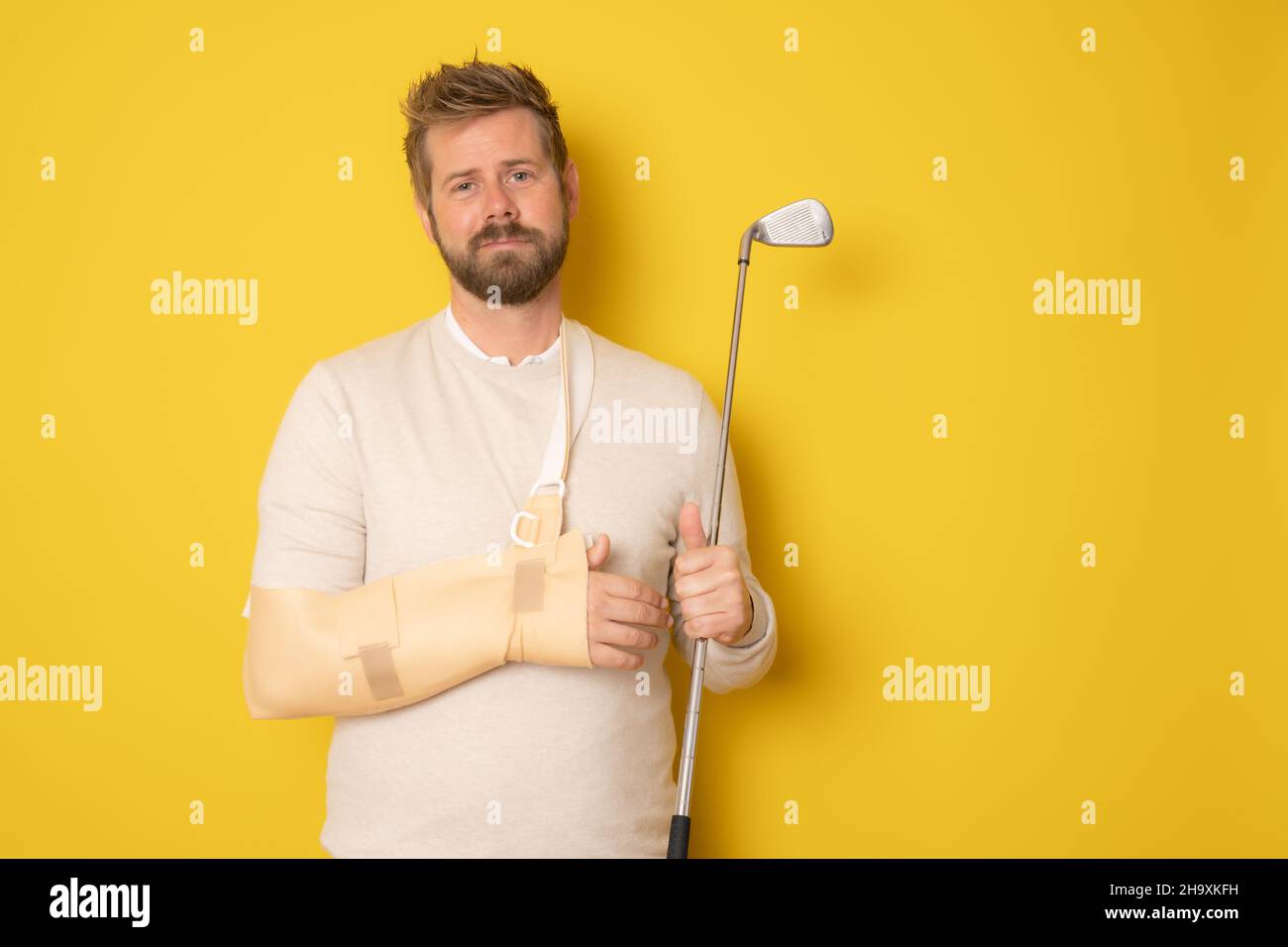 Young golf player man with arm broken with sad expression standing ...