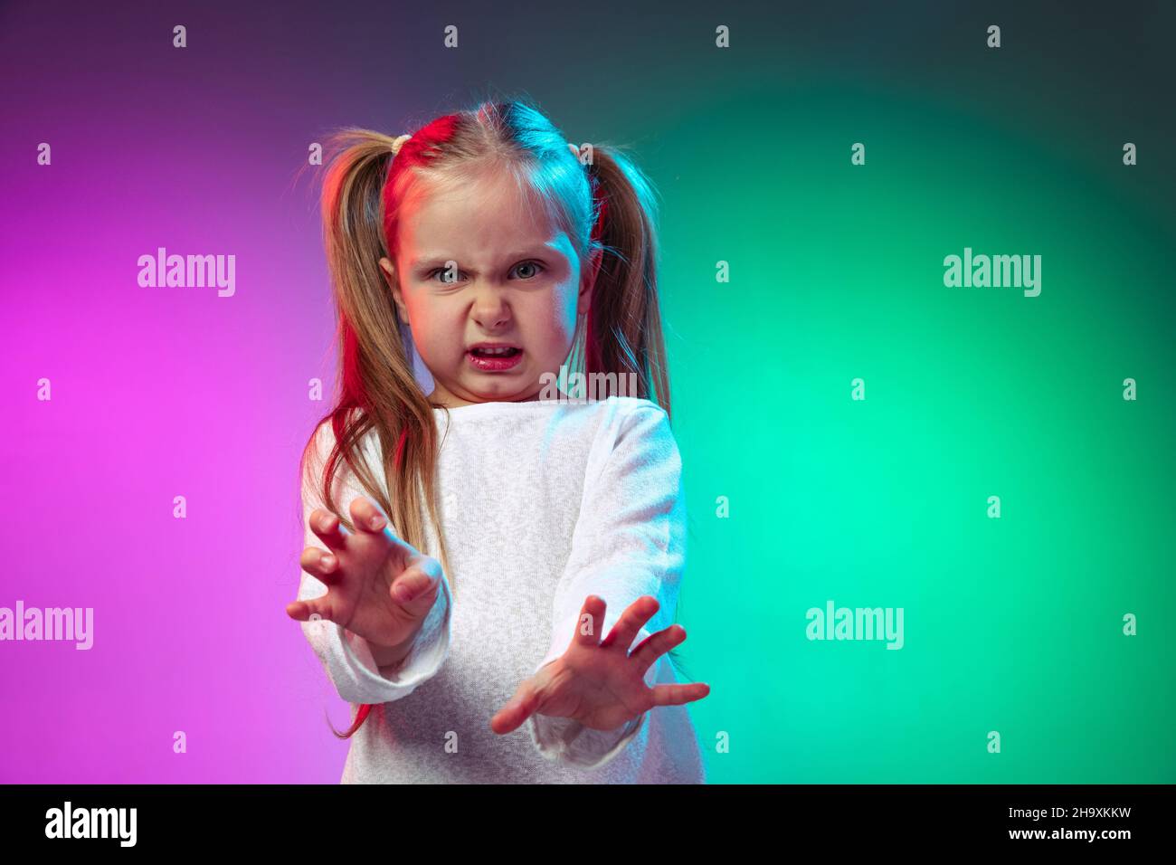 Portrait of little annoyed girl, kid defending against unpleasant ...