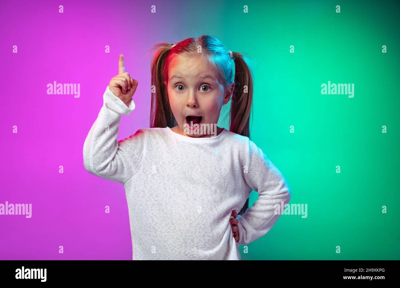 Portrait of little preschool girl, cute kid raising finger up isolated ...