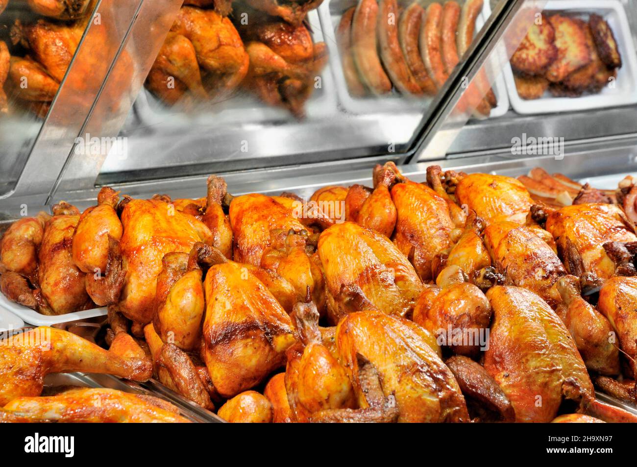 Grilled chicken and other grilled meats in a fast food display Stock ...