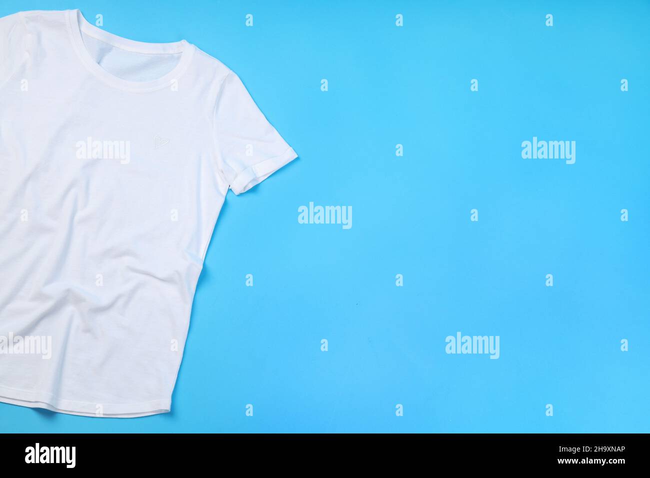 Blank white t-shirt with space for print on blue background Stock Photo ...