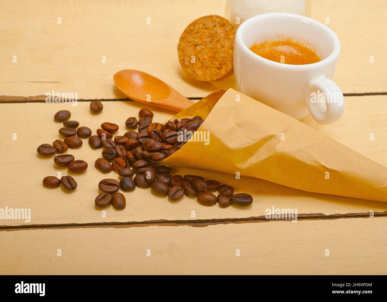 espresso coffee and beans on a paper cone cornucopia over white ...