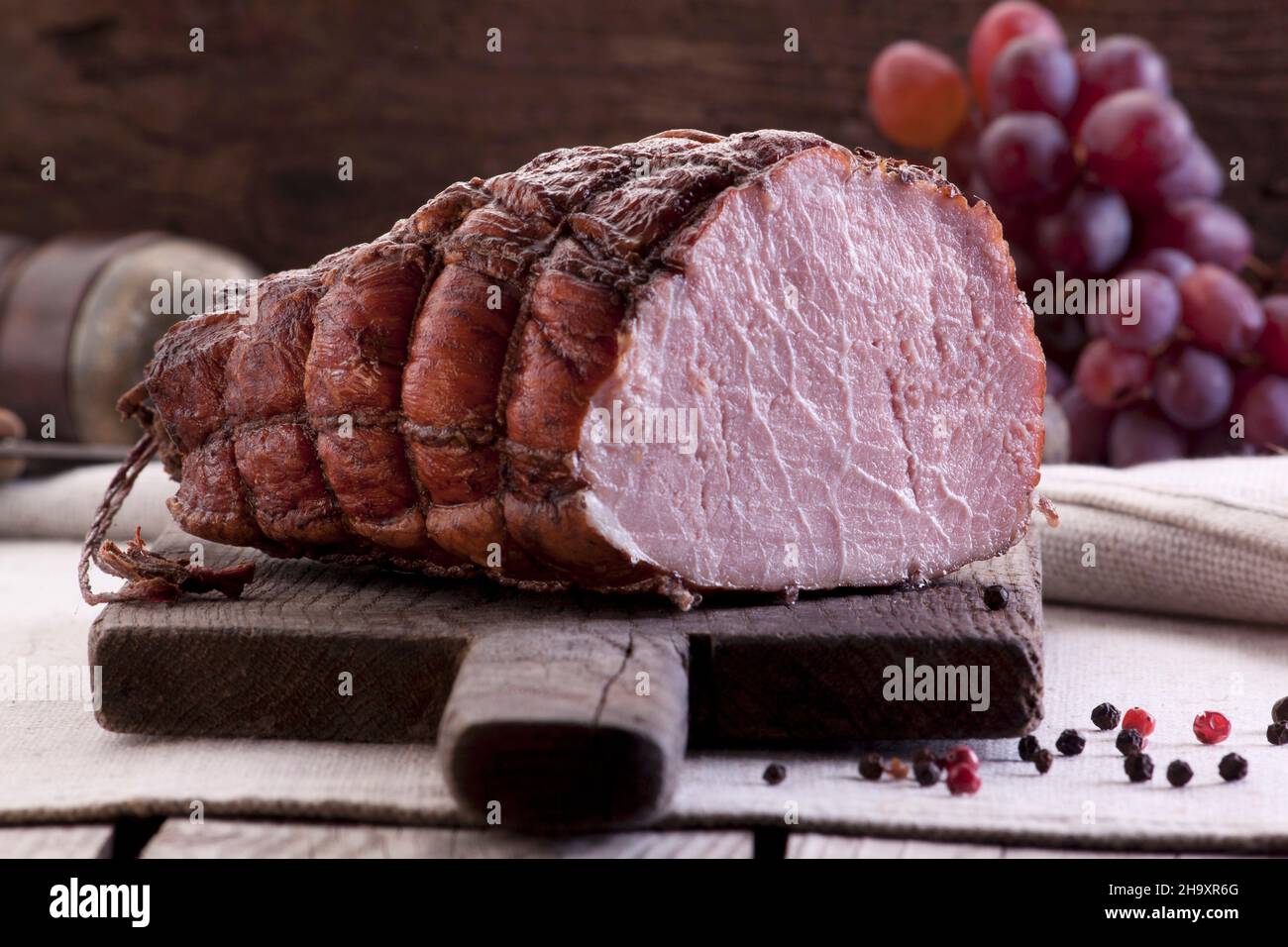 A whole smoked ham in a net Stock Photo - Alamy