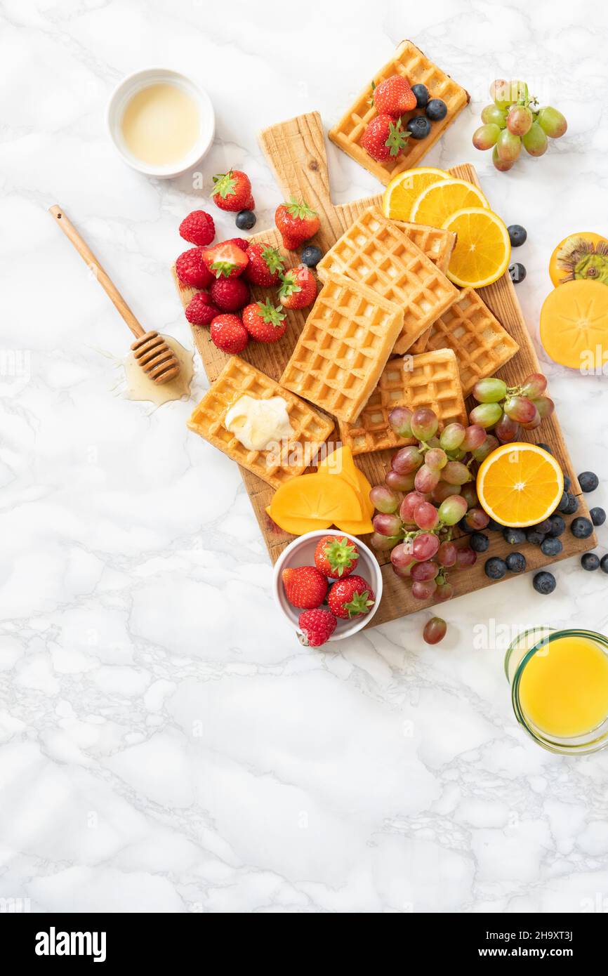 Waffles with fruits and orange juice Stock Photo - Alamy