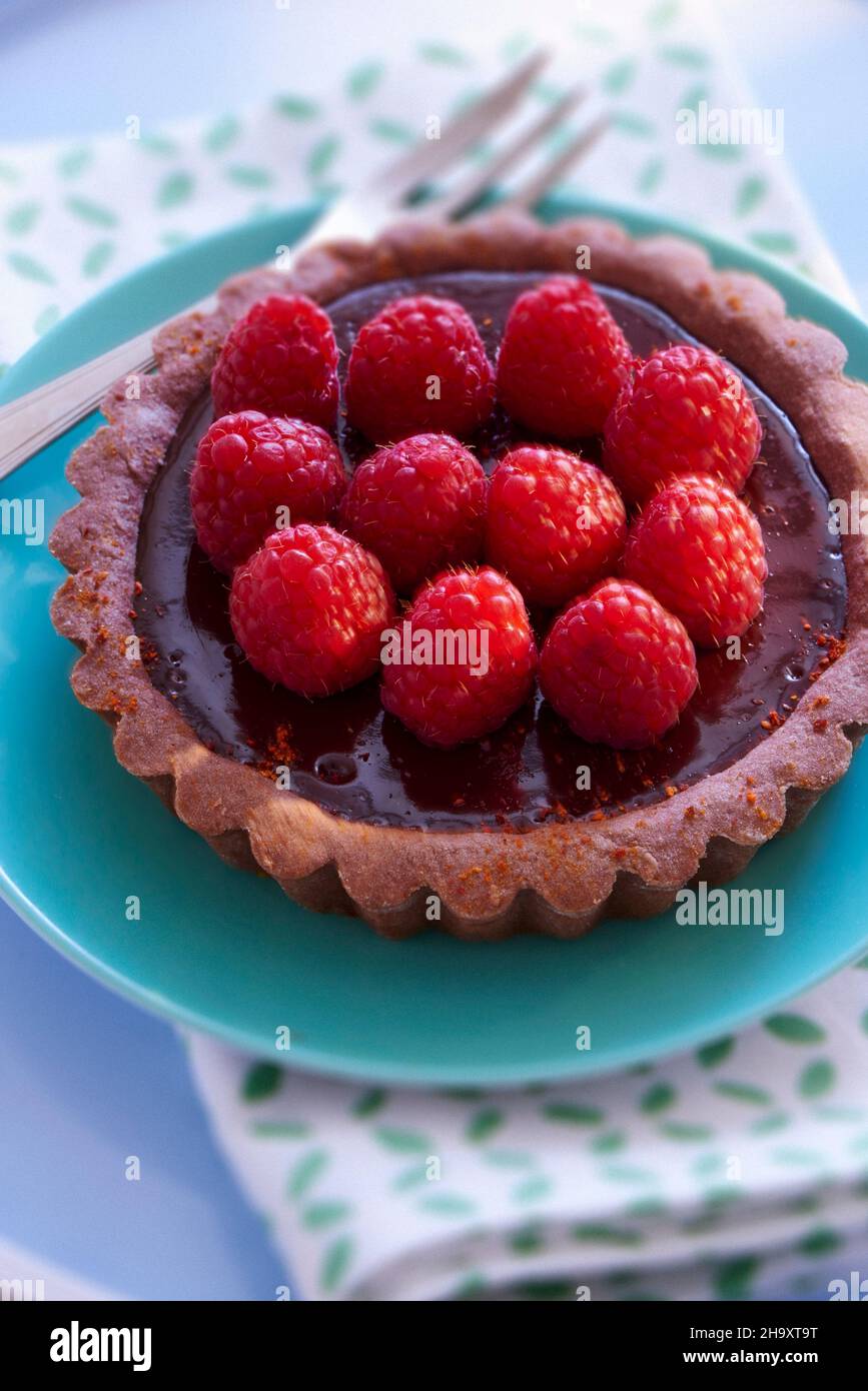 A chocolate and raspberry tartlet Stock Photo - Alamy
