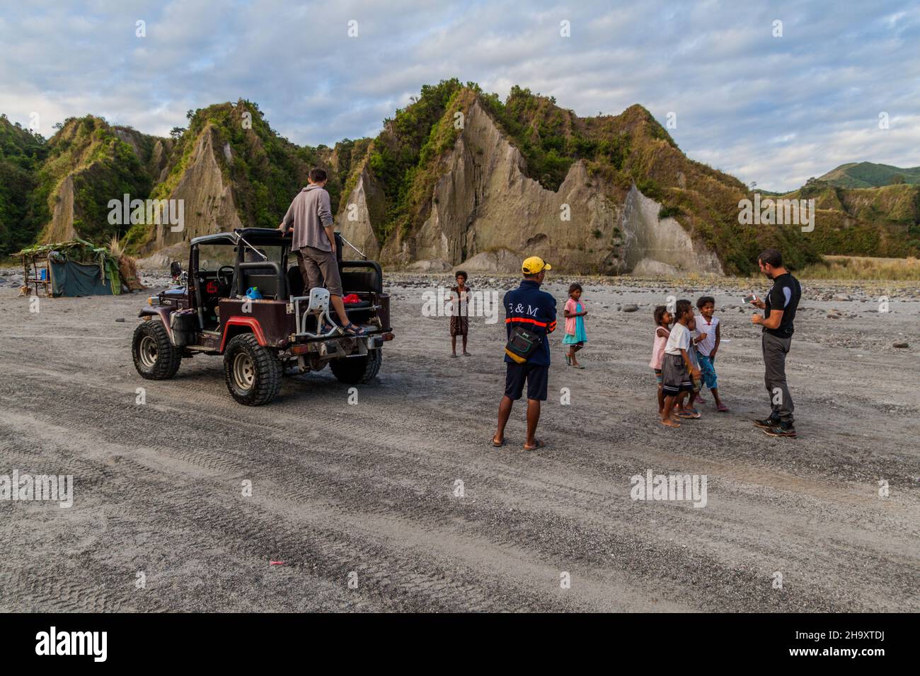MT PINATUBO, PHILIPPINES - JAN 30, 2018: Tourists with local children ...