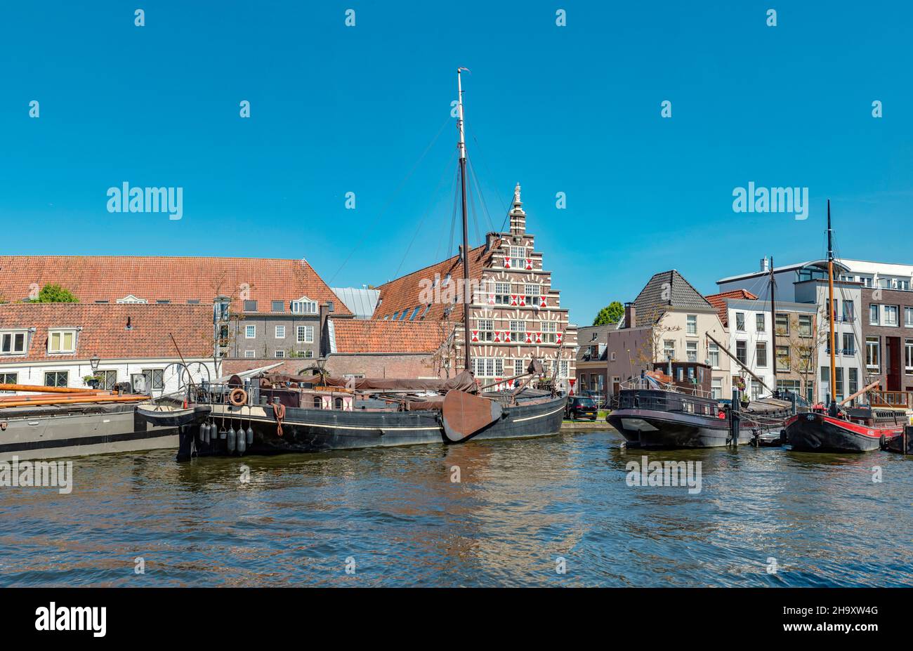Stepped gable house and ships in the river Leidse rijn Stock Photo - Alamy