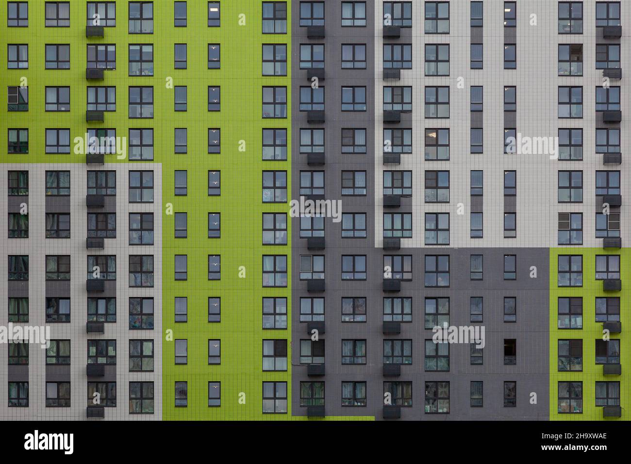 Fragment of the wall of a multi-storey building in green, white and ...