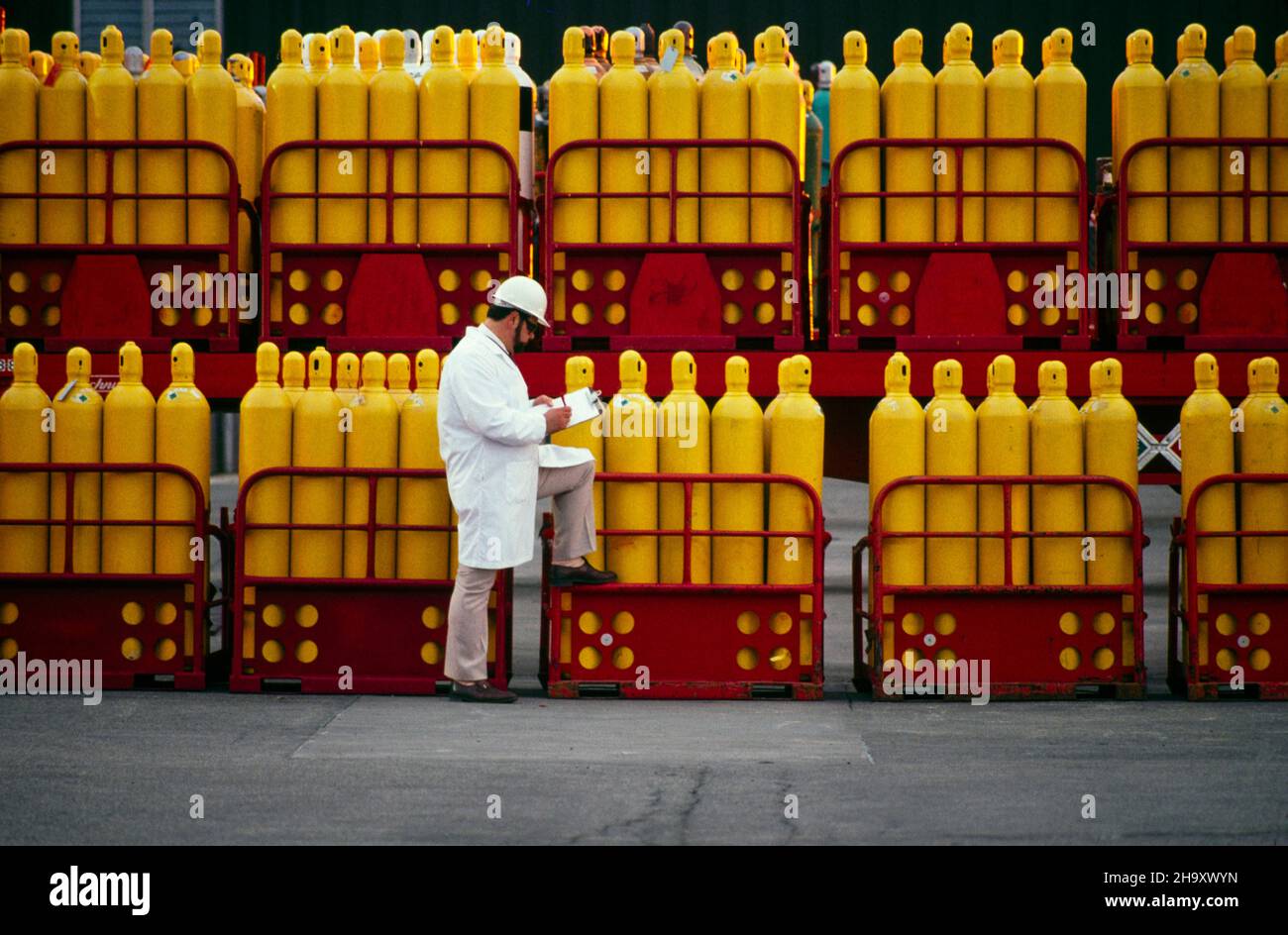 worker checking gas tanks at a depot in New Jersey Stock Photo - Alamy