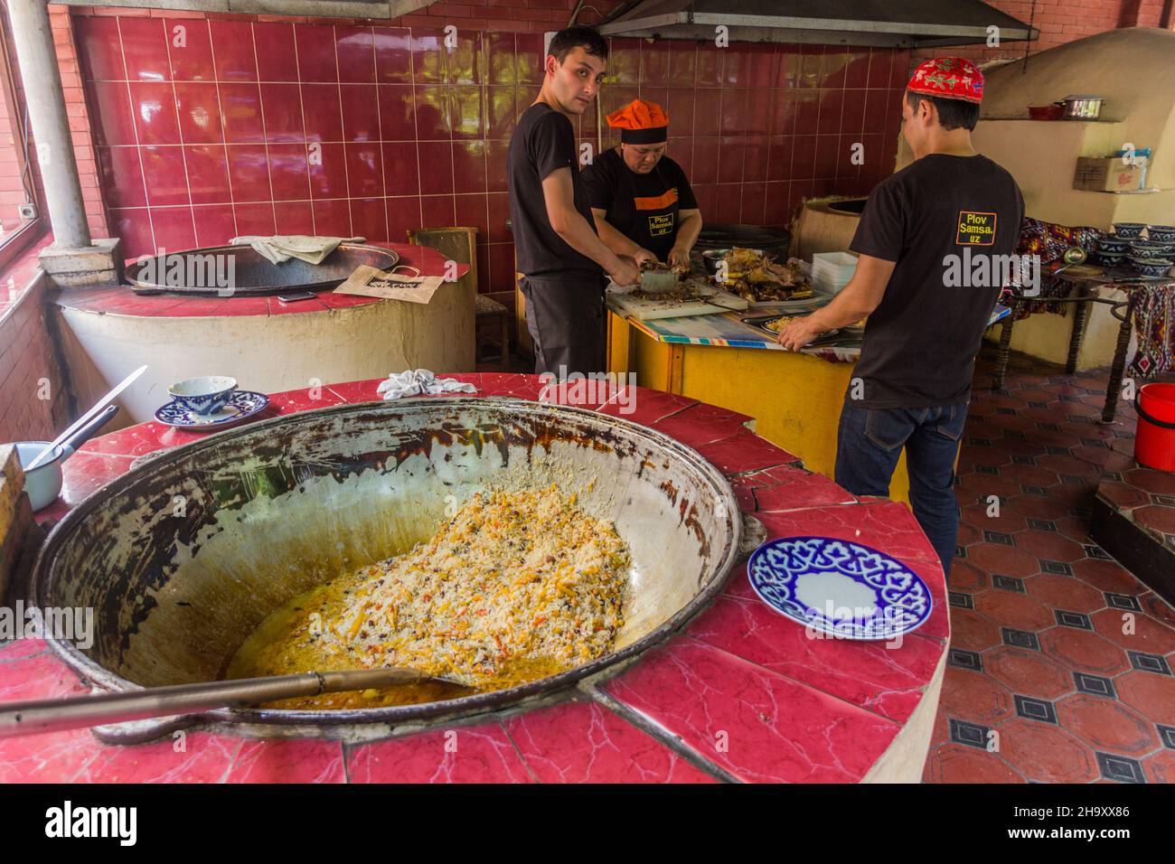 TASHKENT, UZBEKISTAN - MAY 3, 2018: Cooking of plov in the Kazan ...