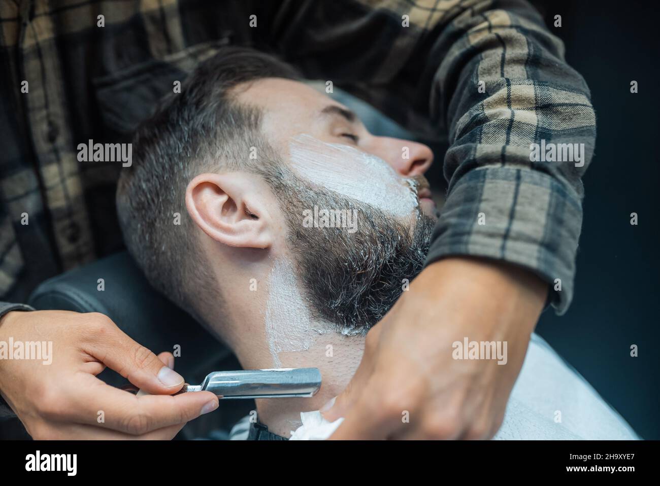 Young man getting head shaved hi-res stock photography and images - Alamy