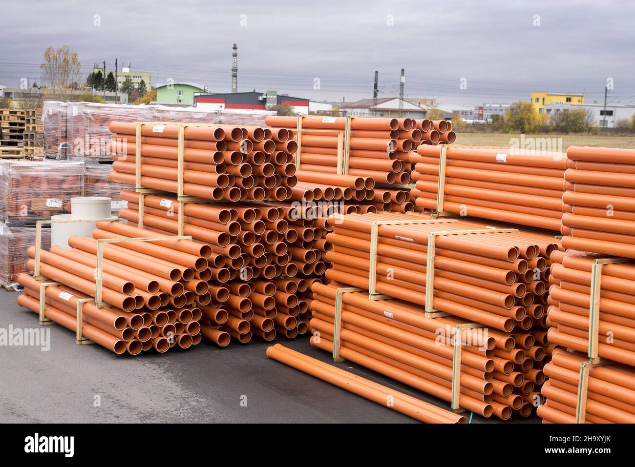 Stack of pipes on sale in a factory Stock Photo - Alamy