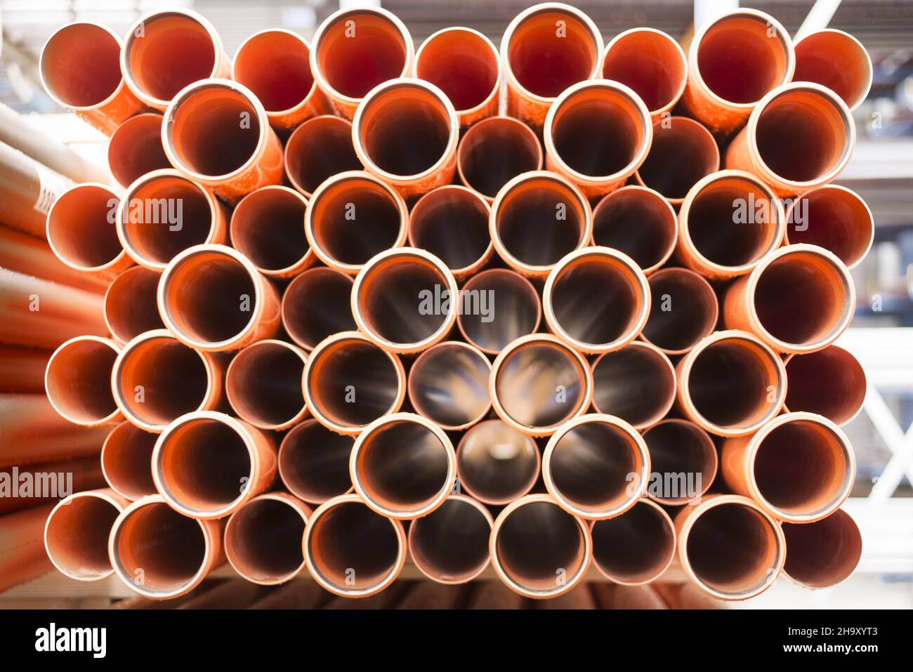 Stack of pipes on sale in a factory Stock Photo - Alamy