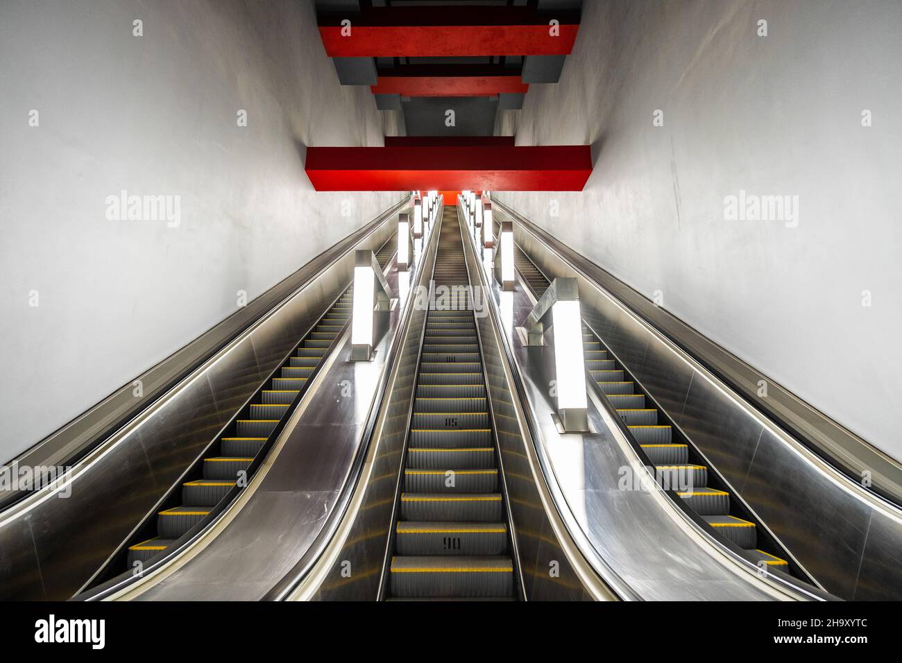 An empty modern escalator going up high. Linear perspective Stock Photo ...