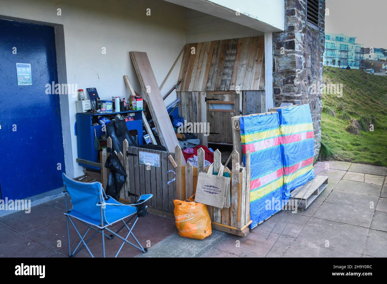 Homeless persons shelter underneath a utility building on the sea front ...